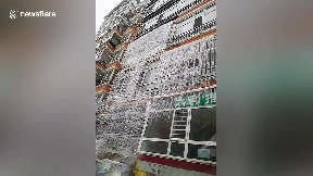 Wall of ice forms on residential building as baltic weather hits ...